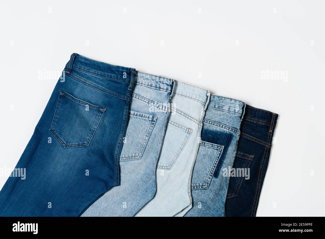 flat lay of different blue jeans on white background, top view Stock ...