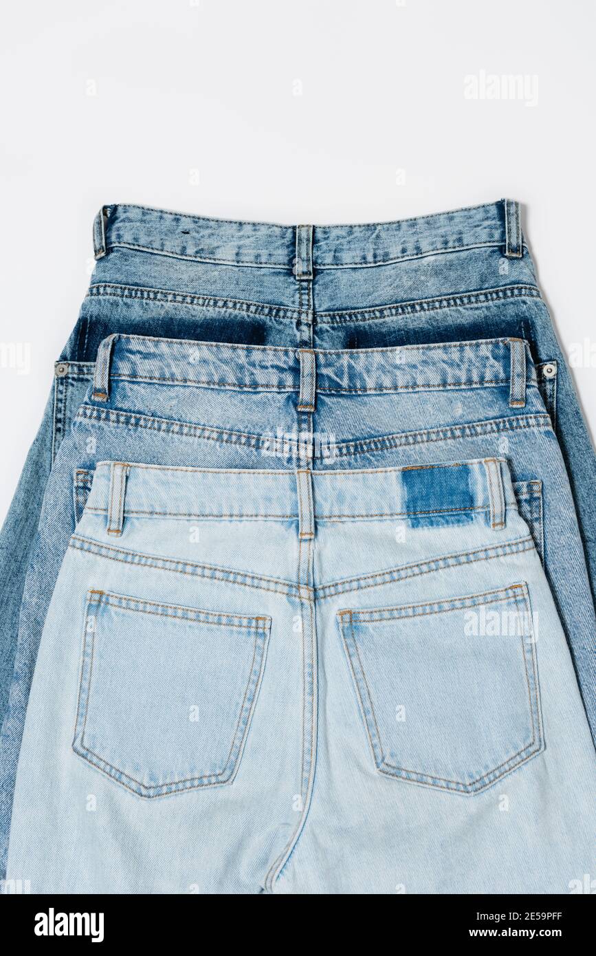 top view of different blue jeans on white background Stock Photo - Alamy