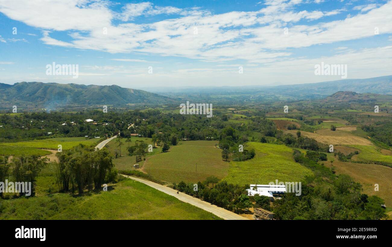 Farmland with crops and sugar cane plantations in a mountain valley ...