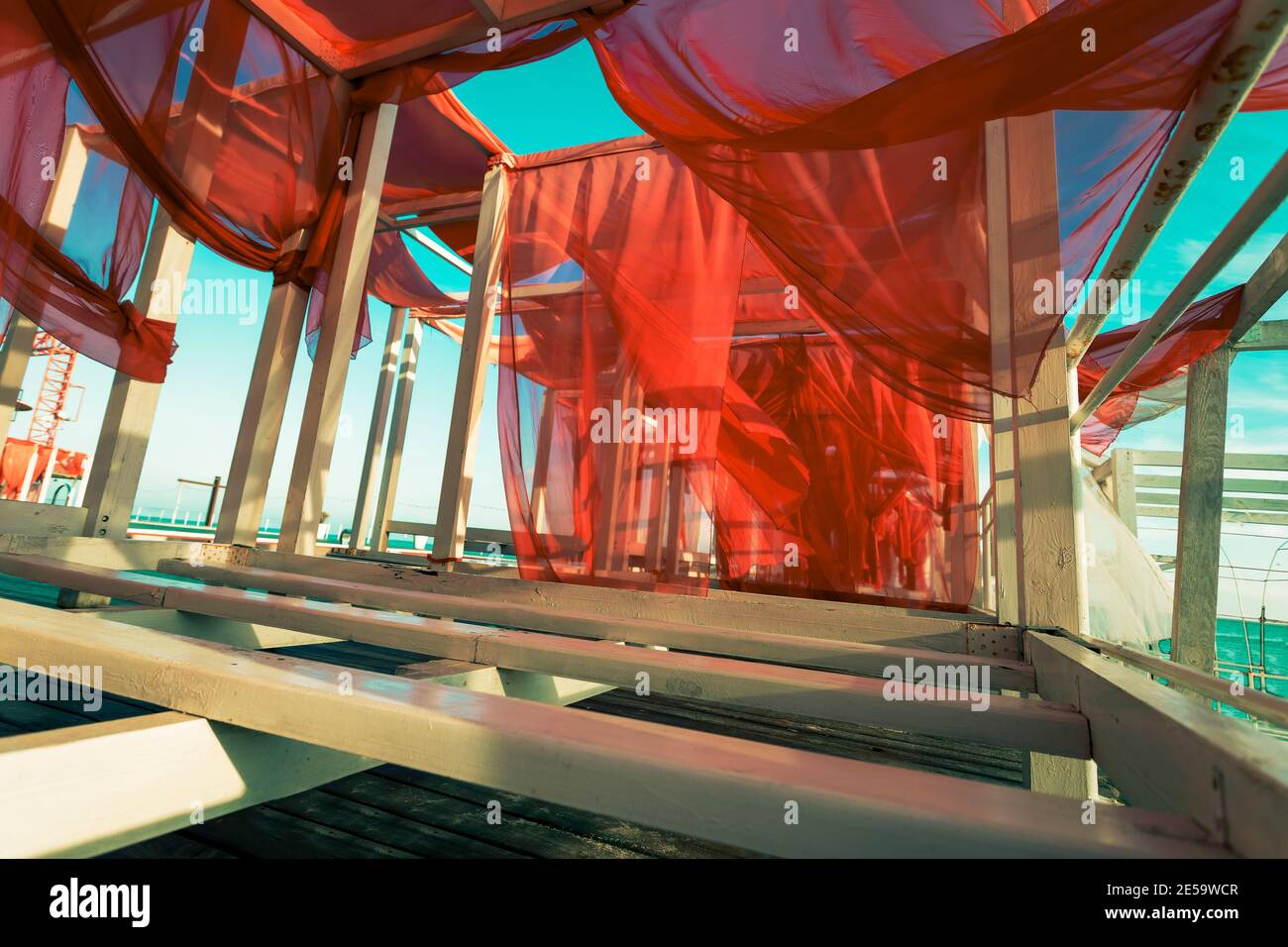 Abstract photographic picture with red sails. Red sails flutter in the ...