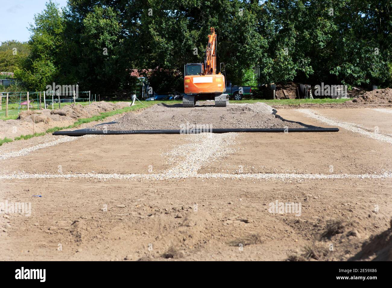 Excavator working on the construction of a horse riding arena Stock ...