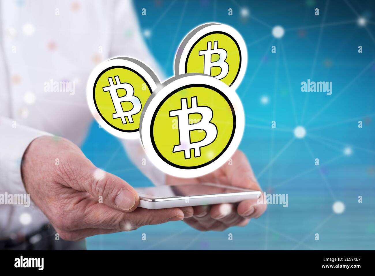 Bitcoin concept above a smartphone held by hands Stock Photo - Alamy