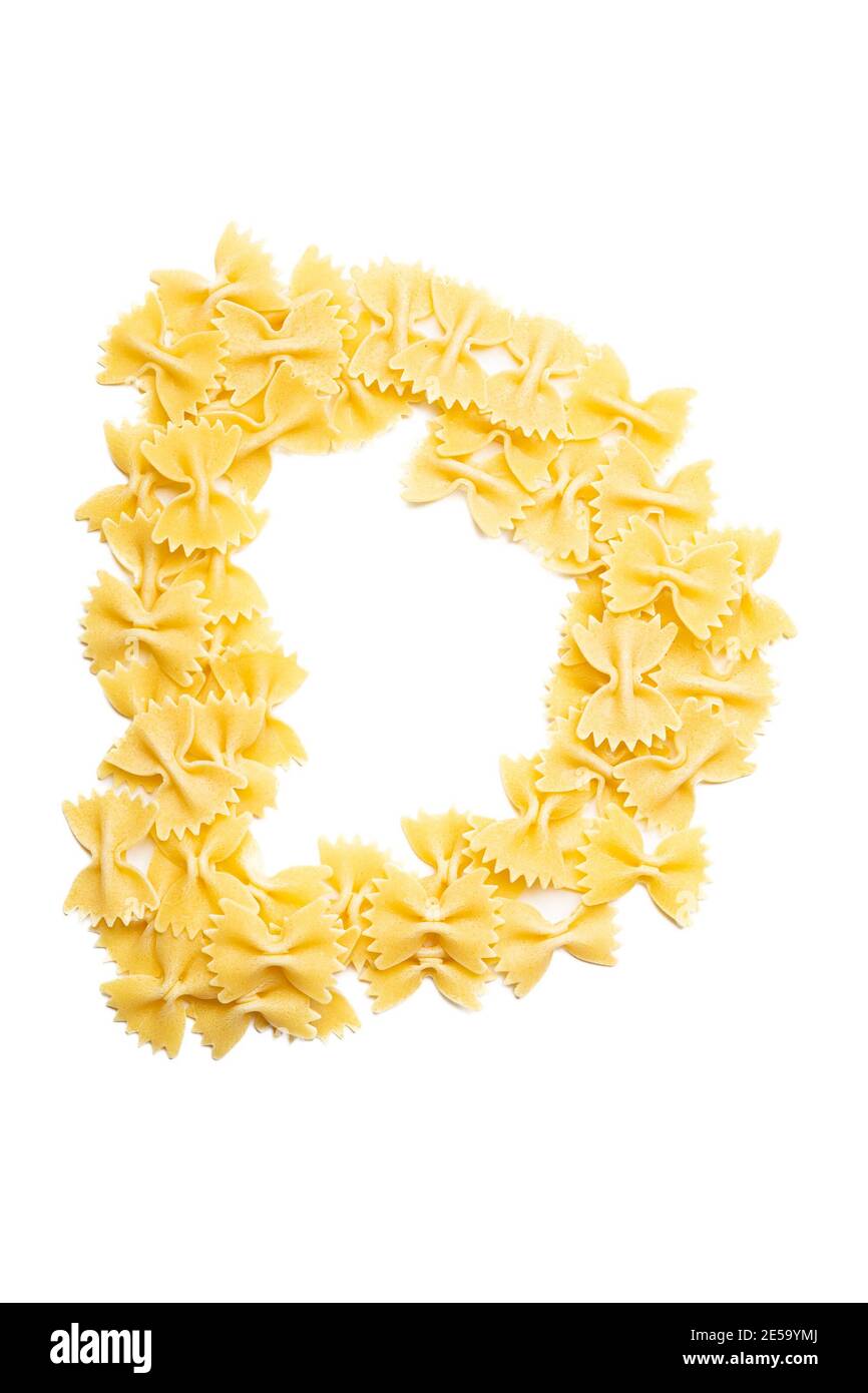 Letter D of the English alphabet from dry farfalle pasta on a white ...
