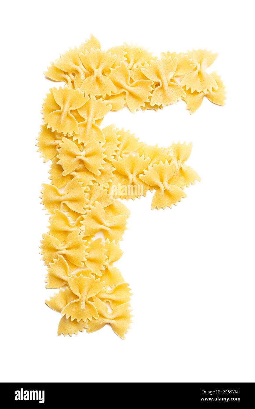 Letter F of the English alphabet from dry farfalle pasta on a white ...