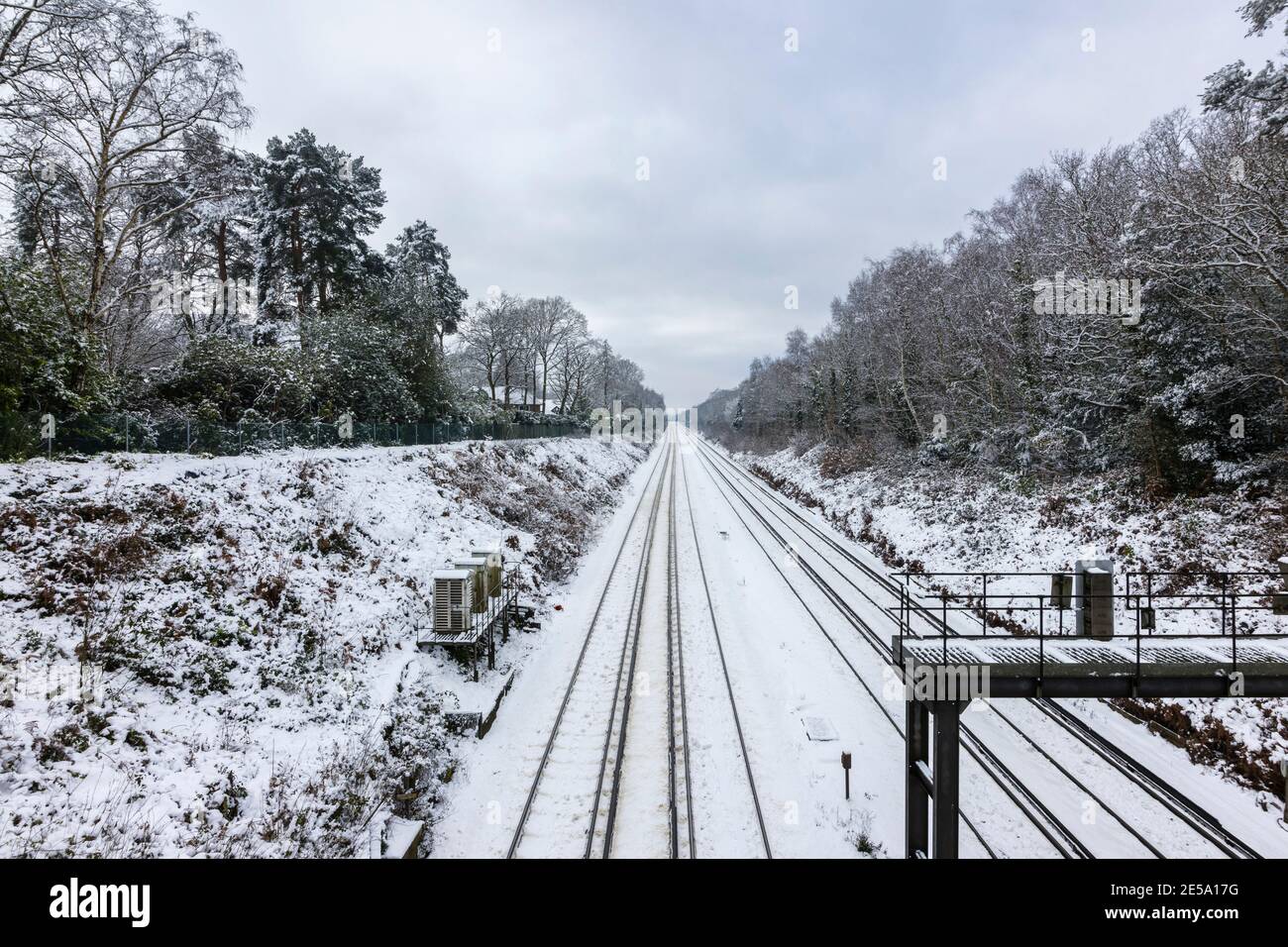 The railway line between Woking and Brookwood in a cutting viewed from ...