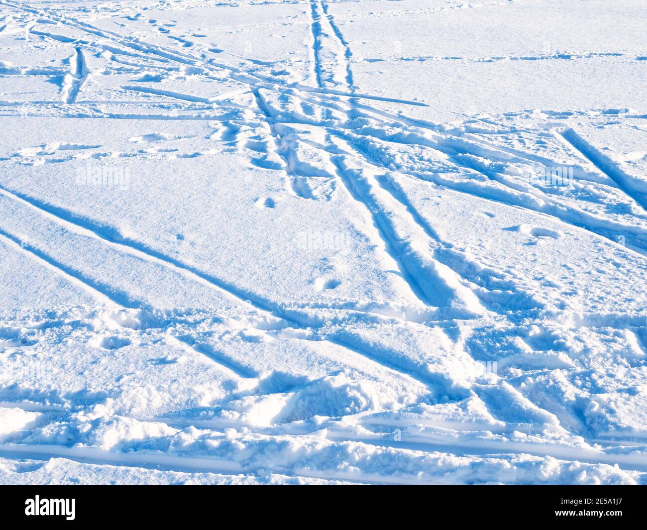 ski tracks in blue snow lit by setting sun in cold winter twiligh Stock ...