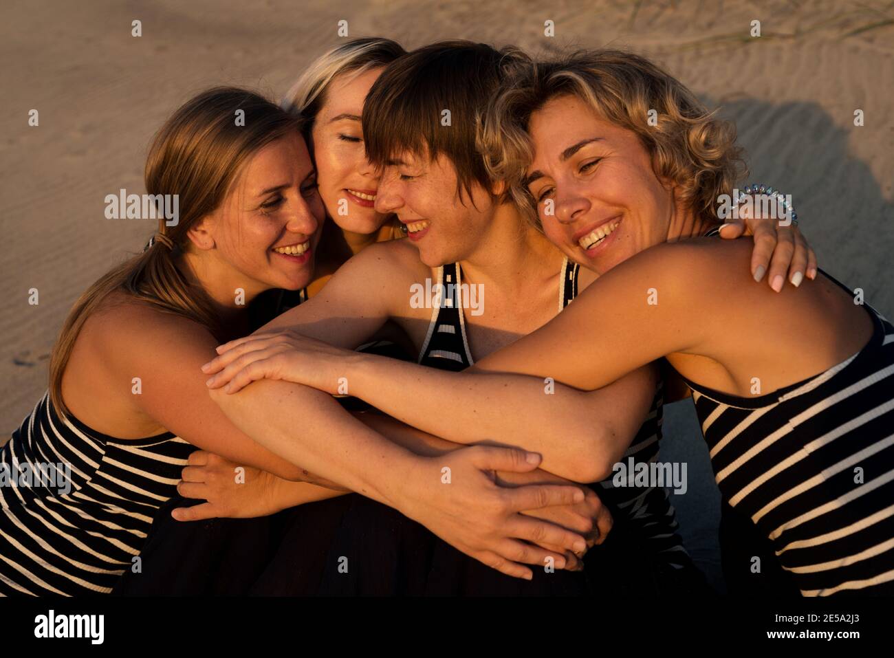 Women laugh and cuddle in nature Stock Photo - Alamy