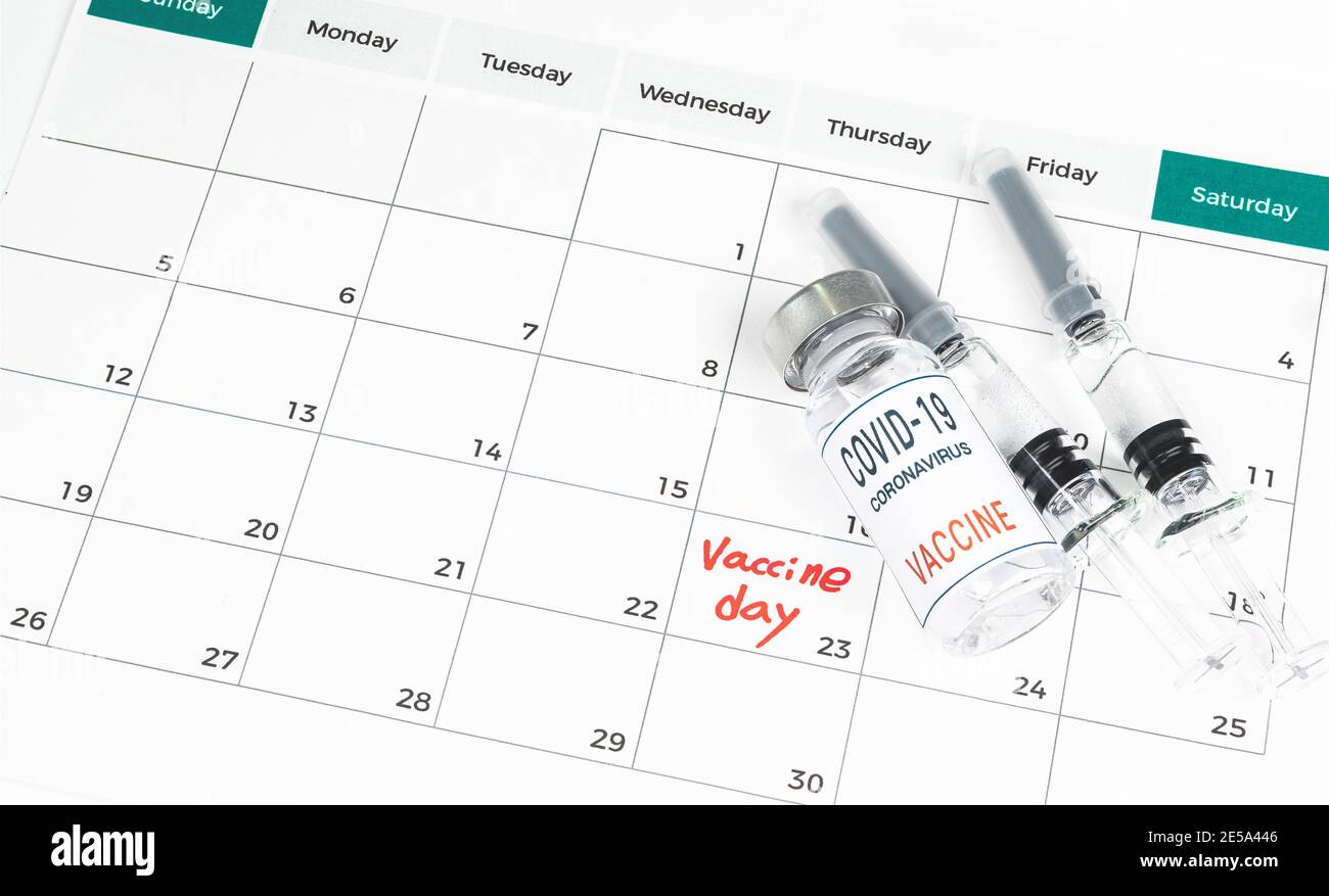 A calendar with vaccination dates, a Covid-19 vaccine, and a medical ...