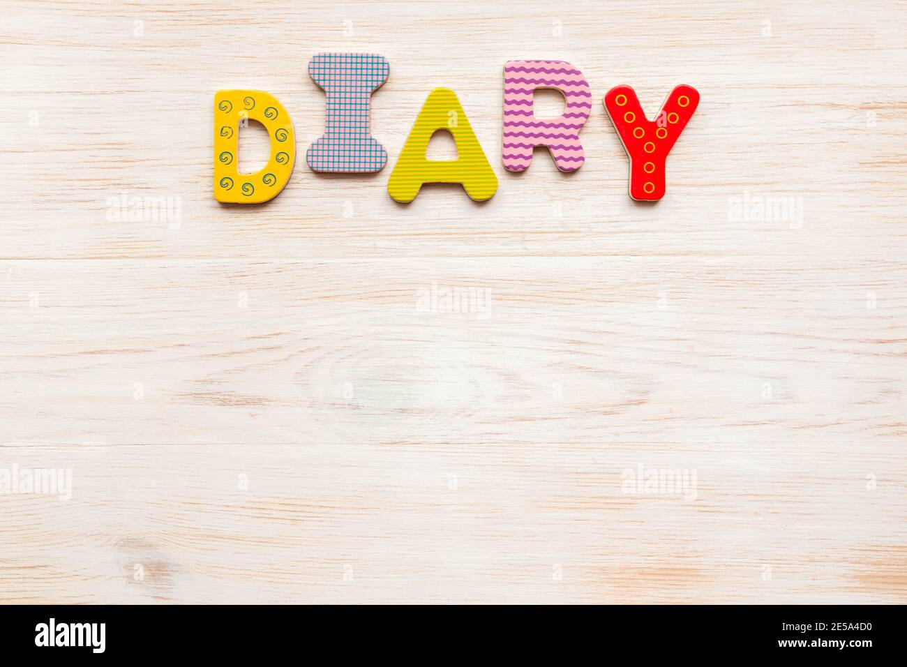 Word diary made of colorful wooden letters on vintage wood background ...