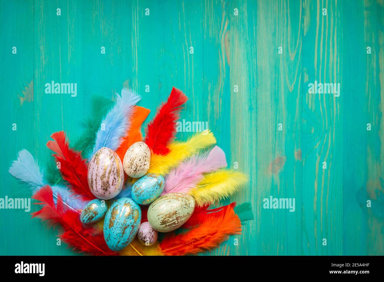 Easter eggs and feathers on vintage wooden turquoise painted table ...