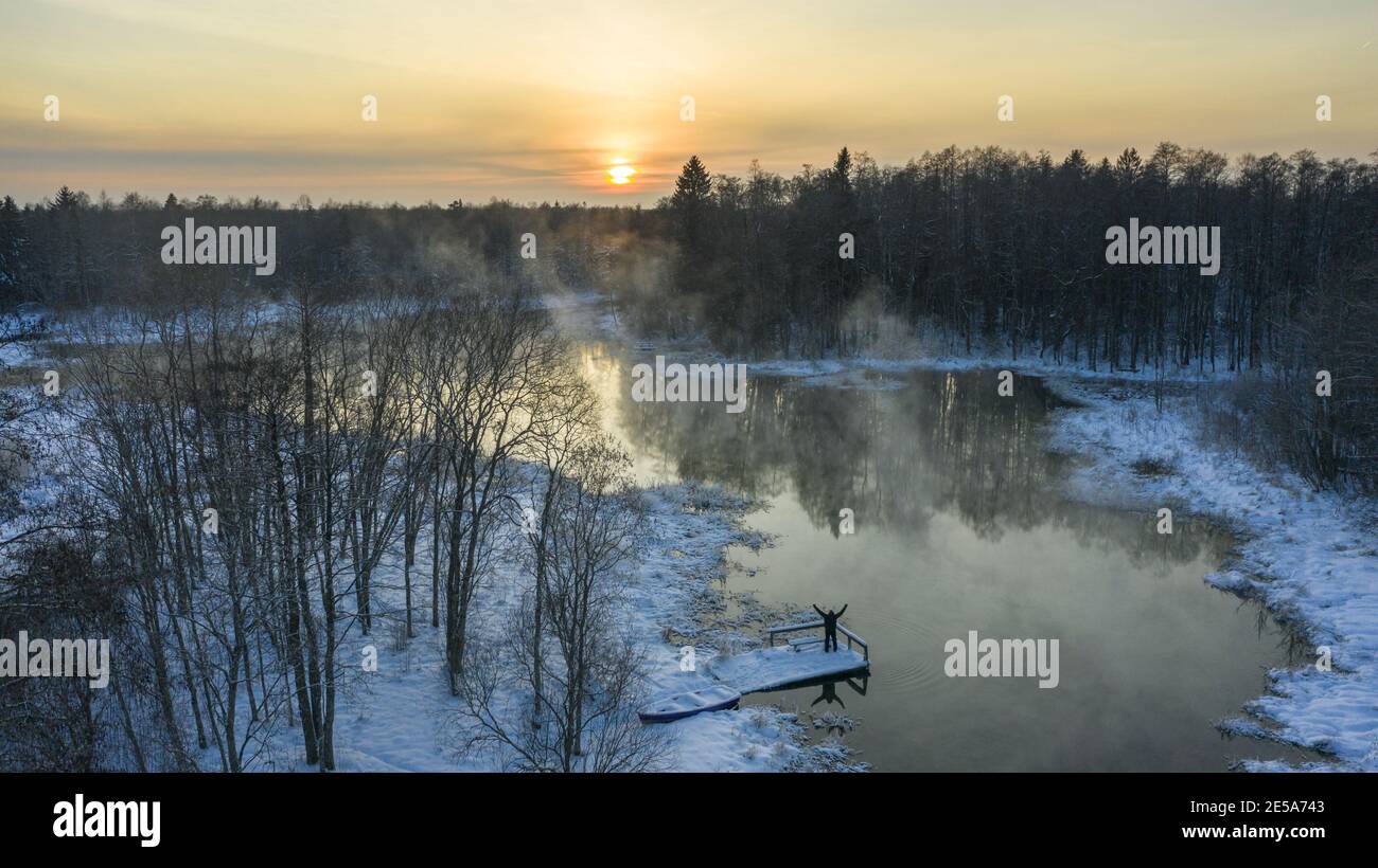Aerial scenery of the steaming groundwater spring during cold winter ...