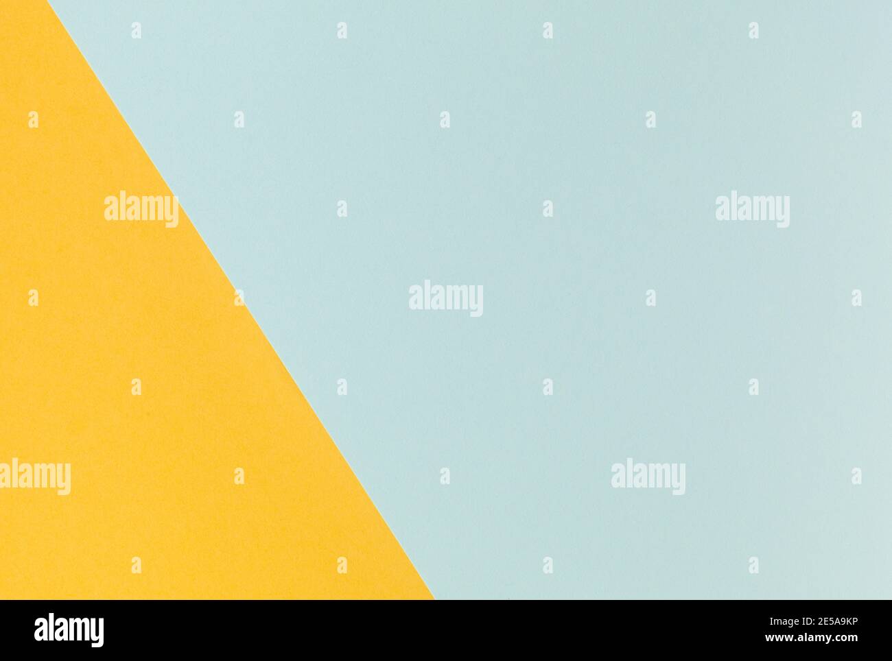 Light blue and yellow pastel color paper geometric flat lay background ...