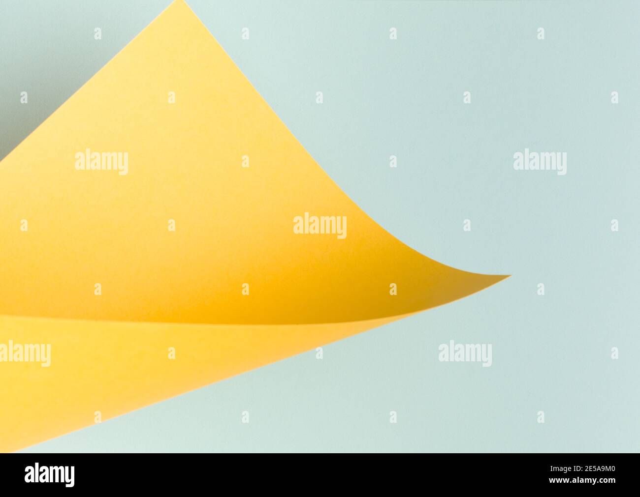 Pastel yellow sheet paper on a light blue paper sheet Stock Photo - Alamy