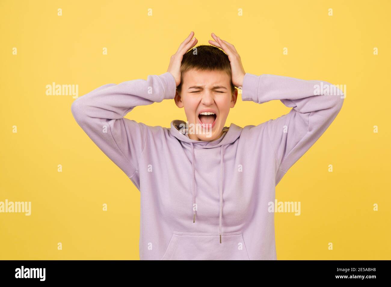 Getting mad screaming. Caucasian girl's portrait isolated on yellow ...