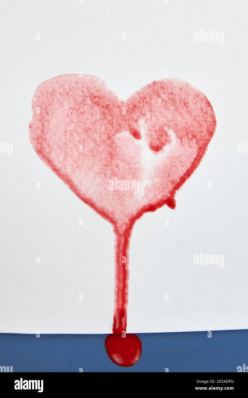 Drawing of a red heart shape with dripping paint in watercolor on white ...
