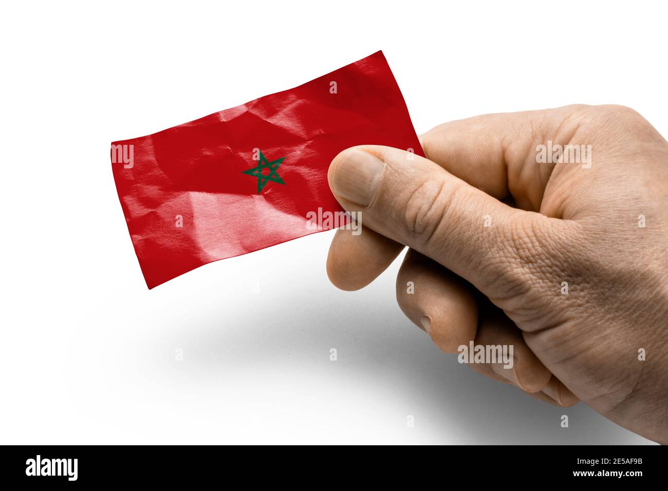 Hand holding a card with a national flag the Morocco Stock Photo - Alamy