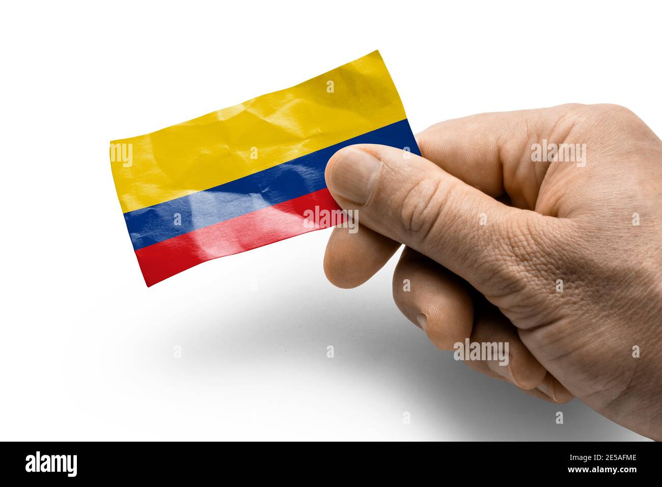 Hand holding a card with a national flag the Colombia Stock Photo - Alamy