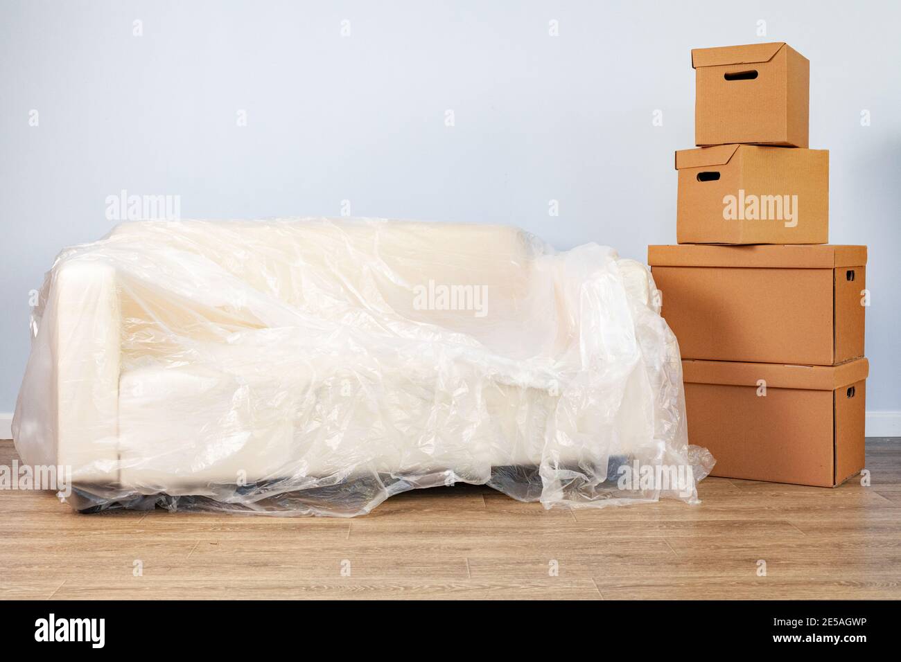 Packed household stuff in boxes and packed sofa for moving Stock Photo ...