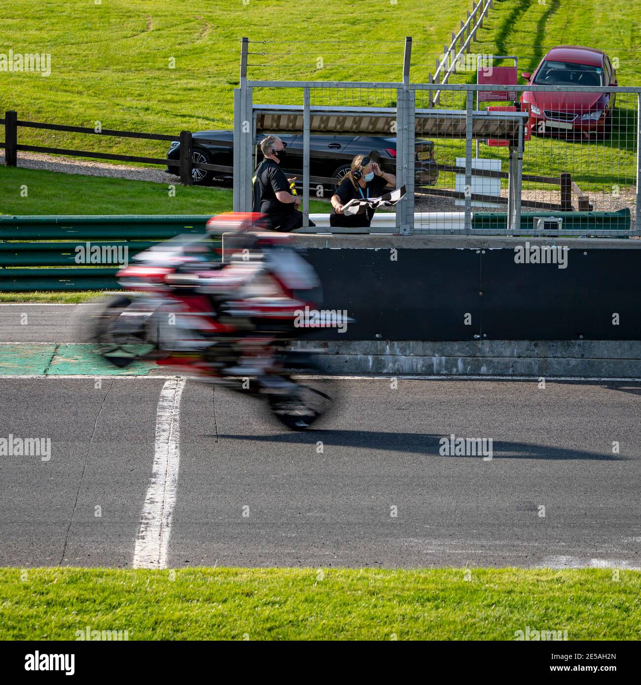 A shot of a racing motorbike as it crosses the finish line Stock Photo ...