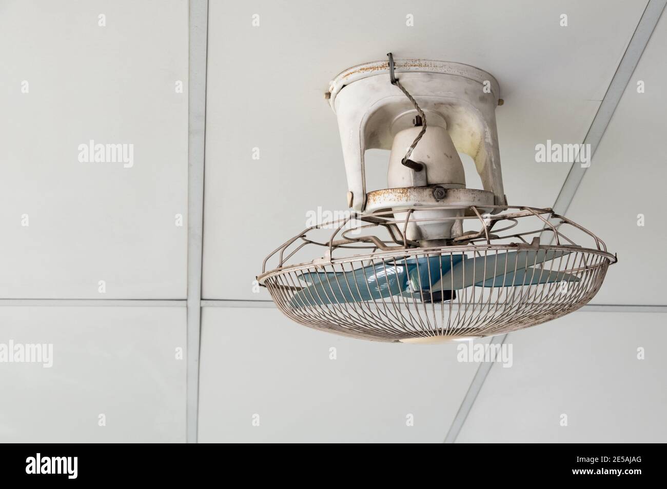 The old orbit fan with the many stains and dust is hanging on the ...
