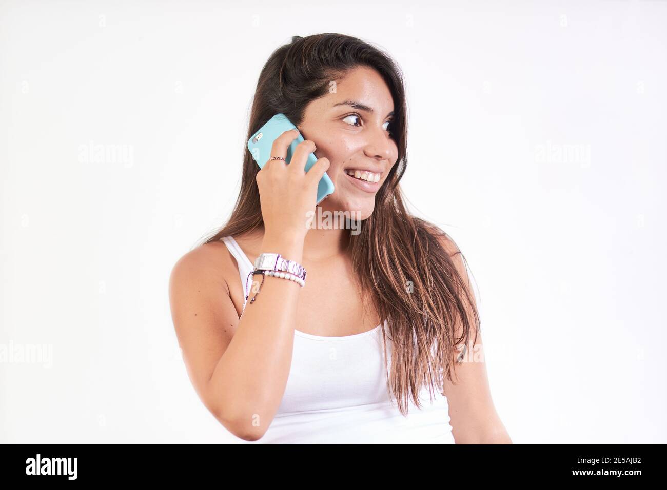 Young female gossiping with her friend on her phone with a shocked ...