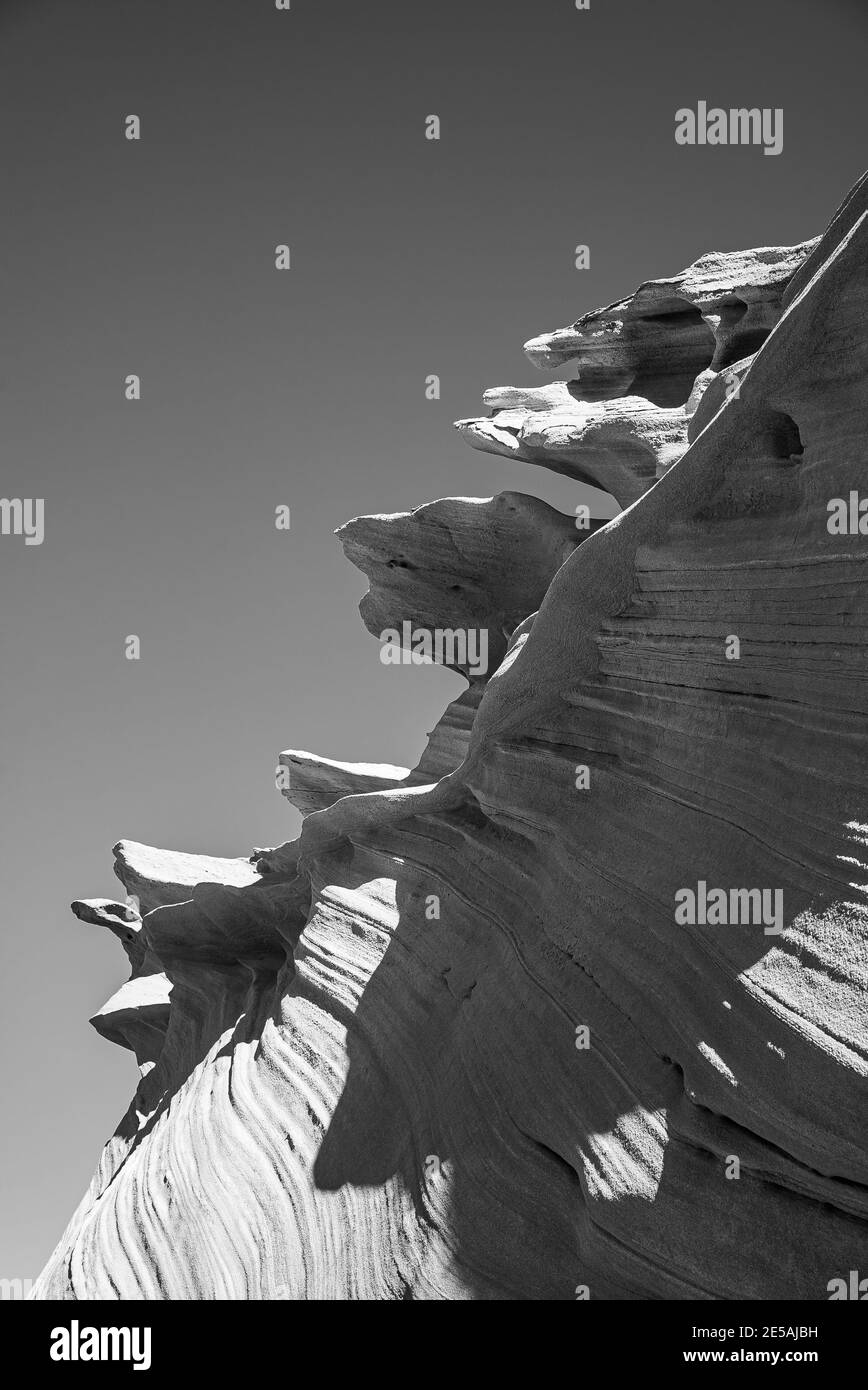 A low angle shot of interesting geometric patterns in coastal cliffs ...