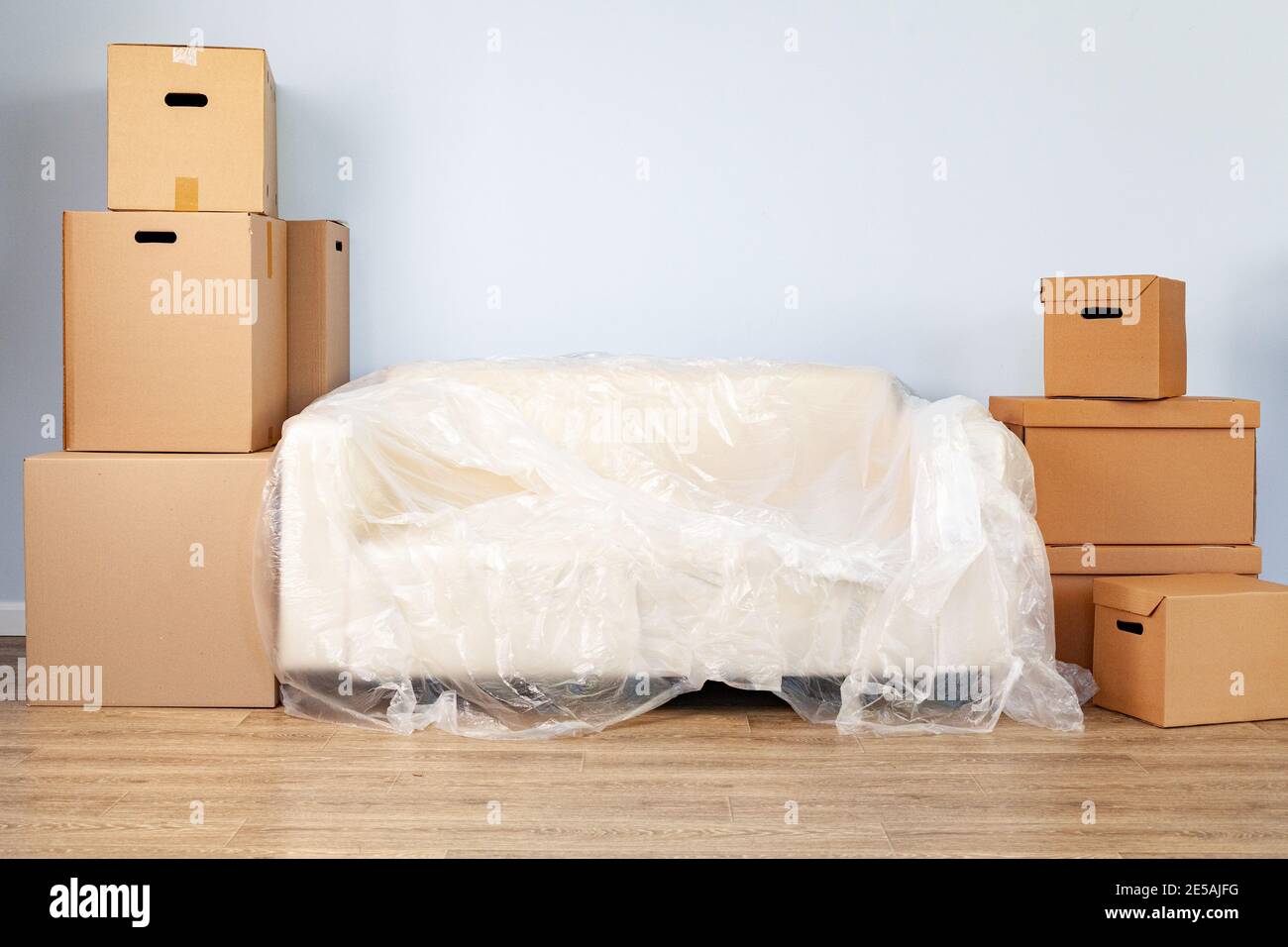 Packed household stuff in boxes and packed sofa for moving Stock Photo ...