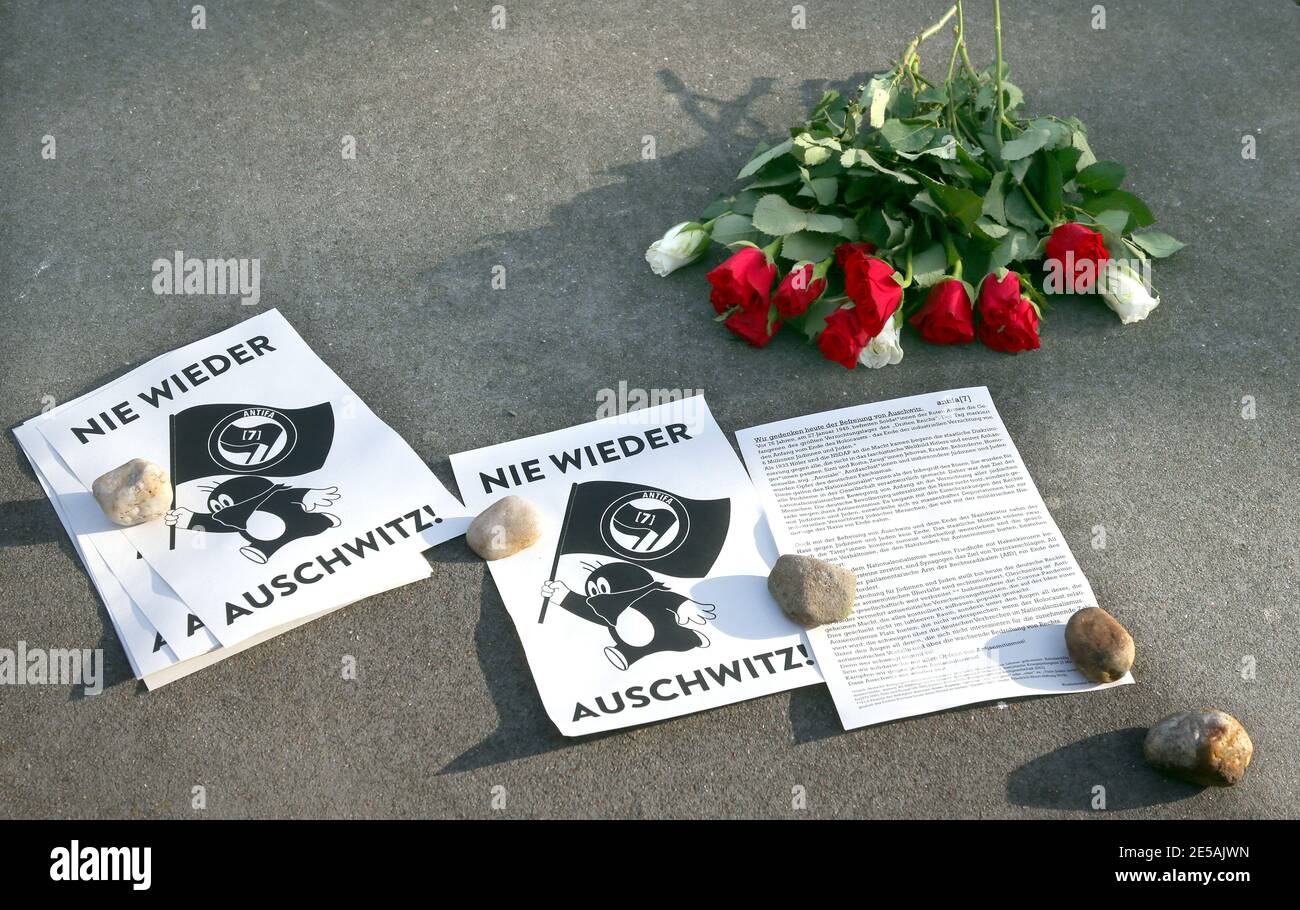 Berlin, Germany. 27th Jan, 2021. Flowers and leaflets lie on one of the ...