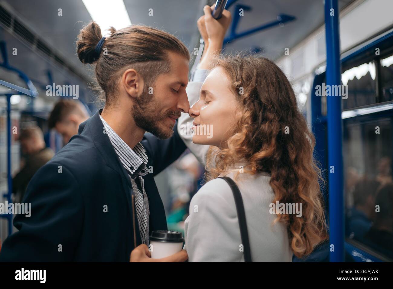 man and woman in love looking at each other on a subway train Stock ...