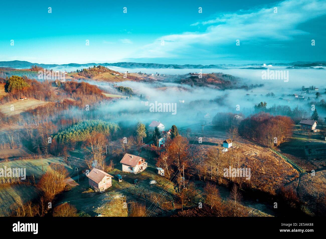 Aerial view of beautiful foggy landscape in Bosnian countryside at ...