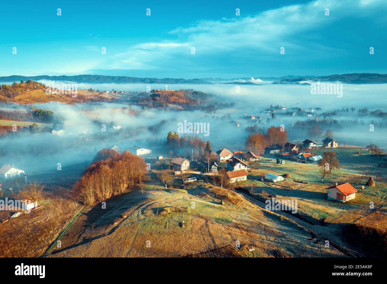 Aerial view of beautiful foggy landscape in Bosnian countryside at ...