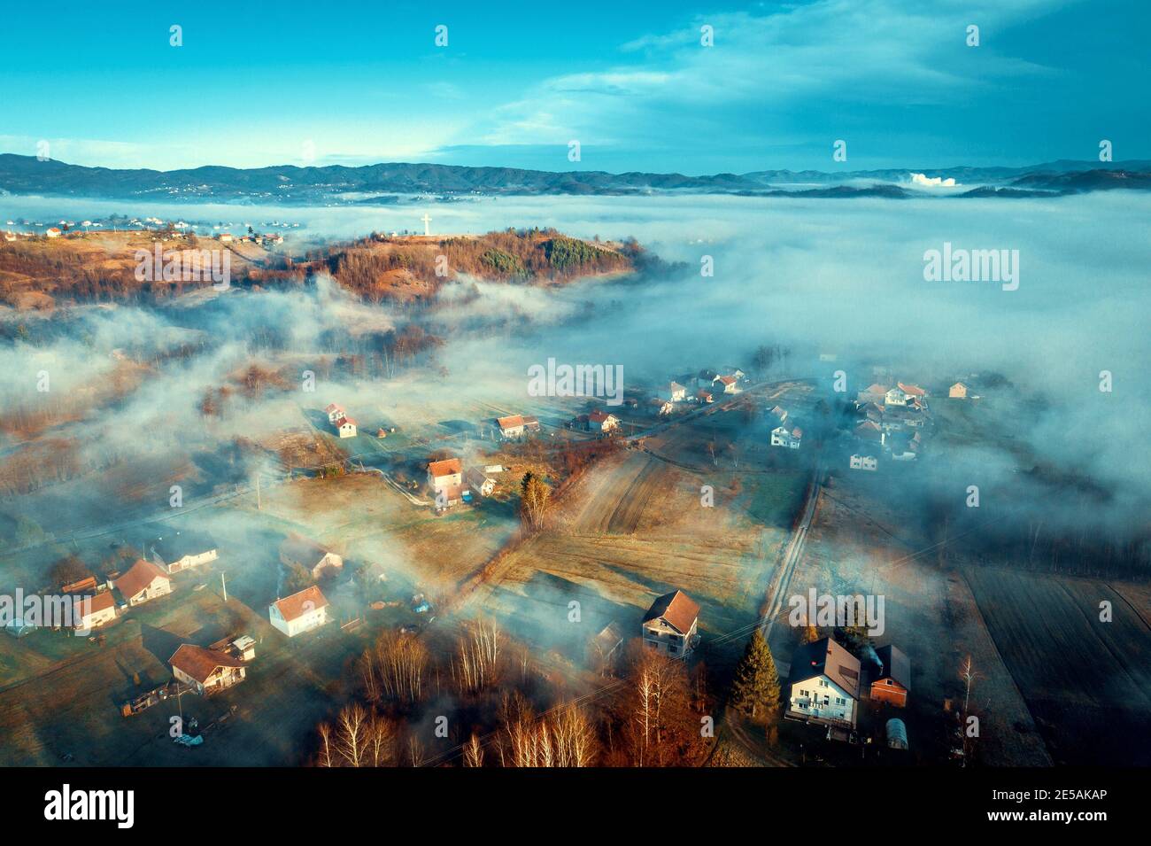 Aerial view of beautiful foggy landscape in Bosnian countryside at ...