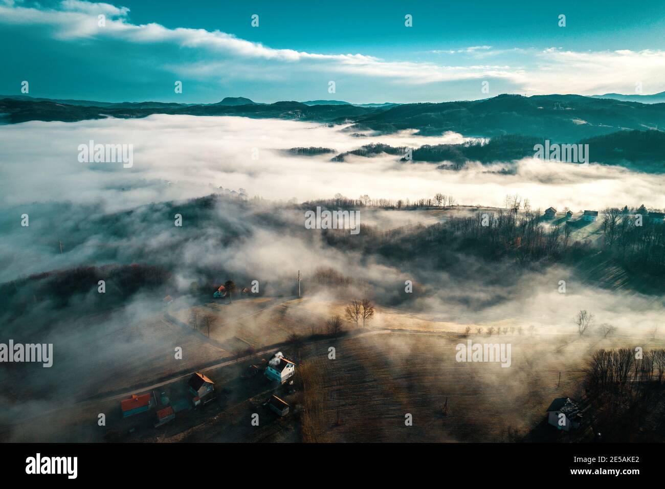 Aerial view of beautiful foggy landscape in Bosnian countryside at ...