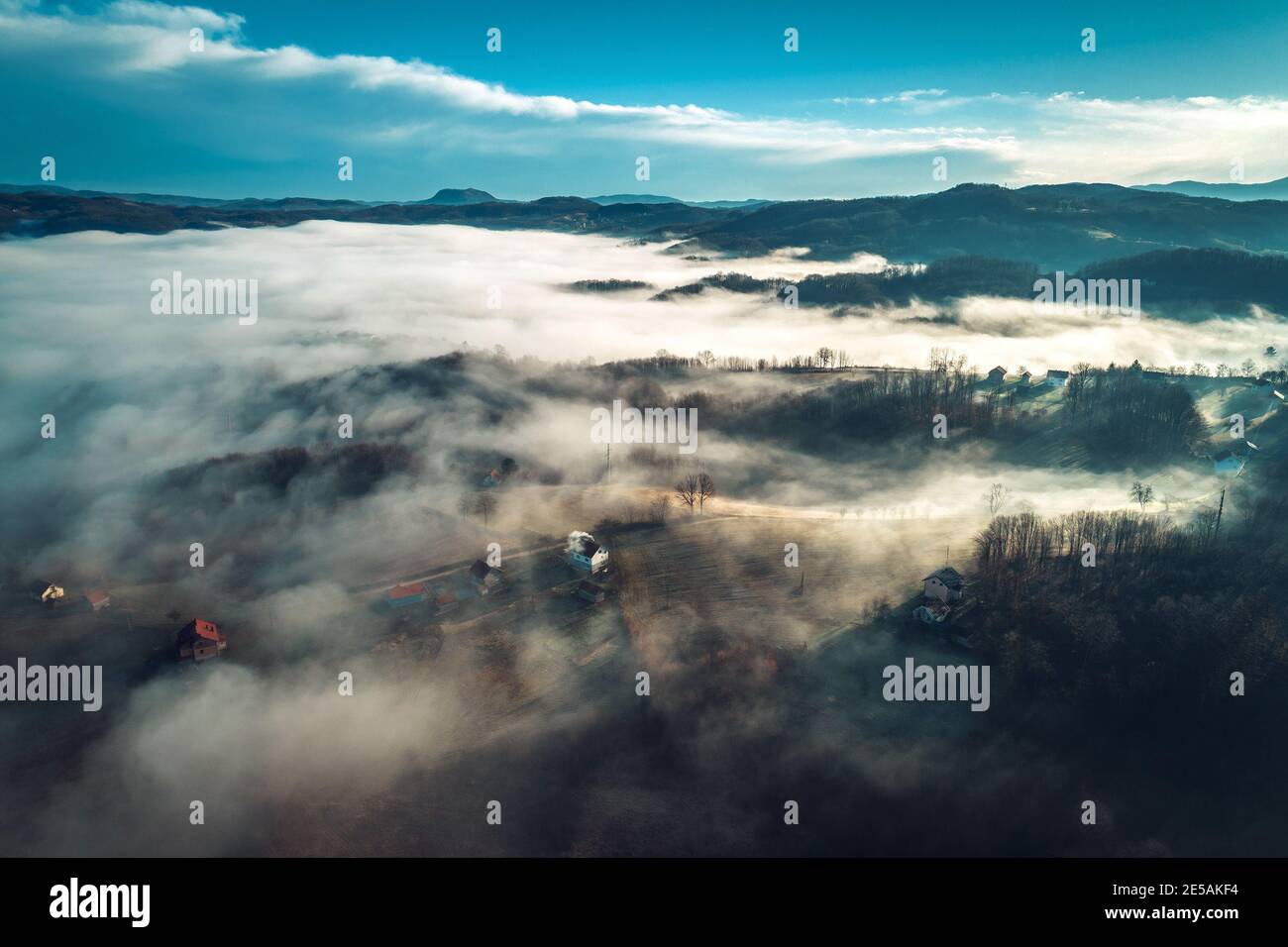 Aerial view of beautiful foggy landscape in Bosnian countryside at ...