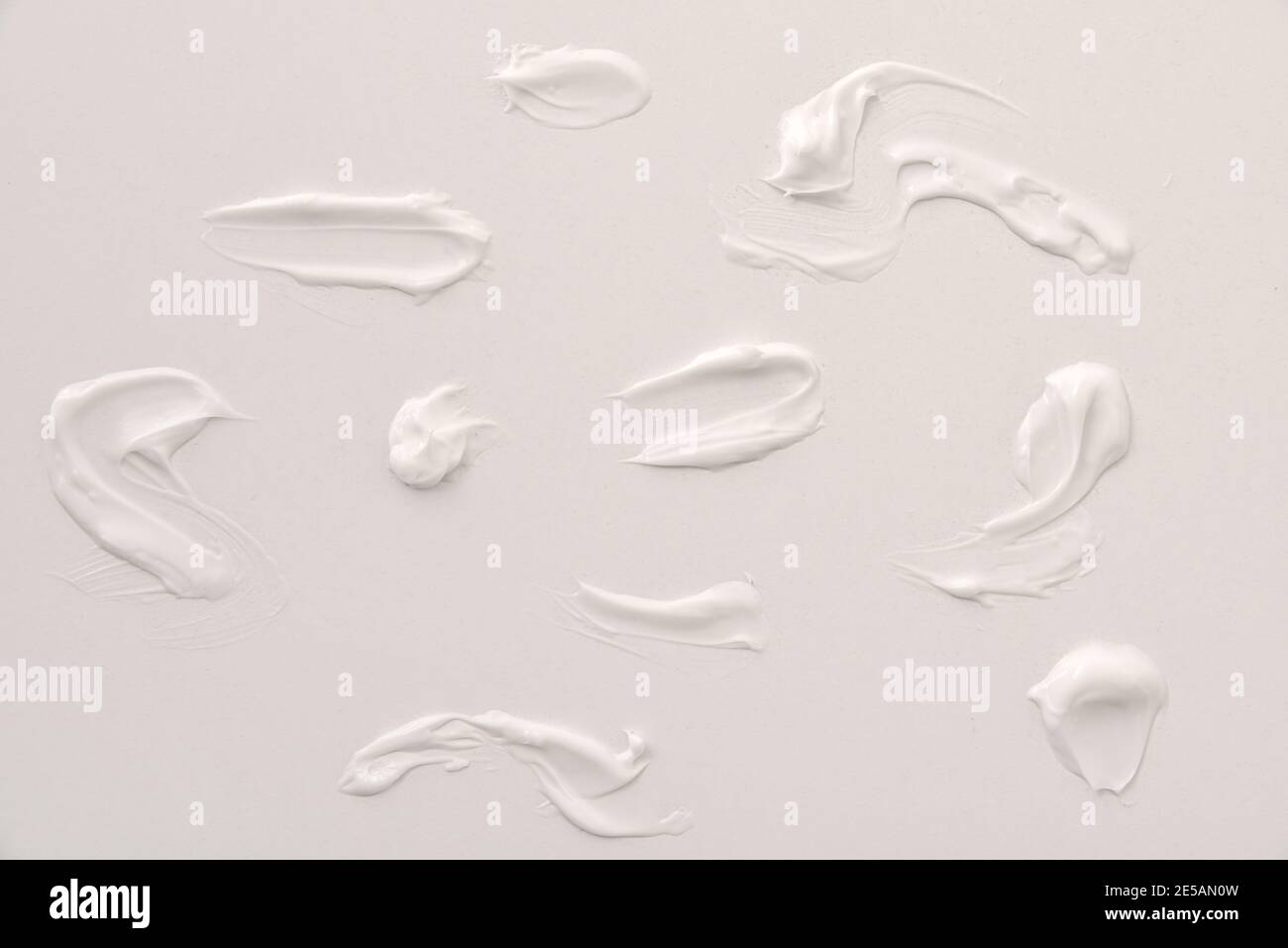 Shapes collection with body cream spots on white table. Top view ...