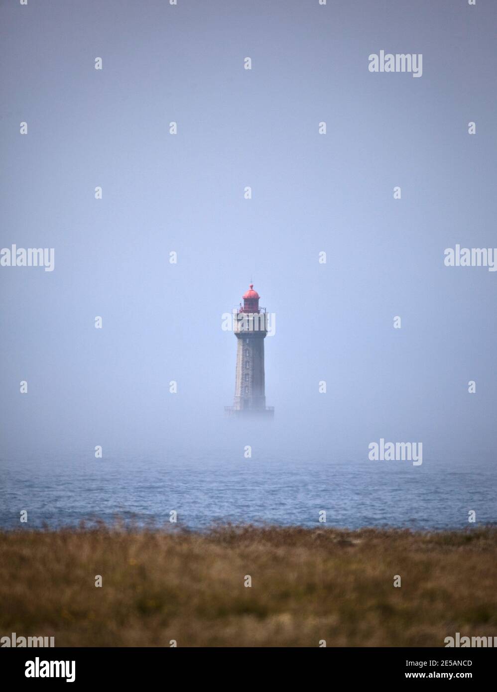 The dramatic La Jument lighthouse, shrounded in summer fog, off the ...