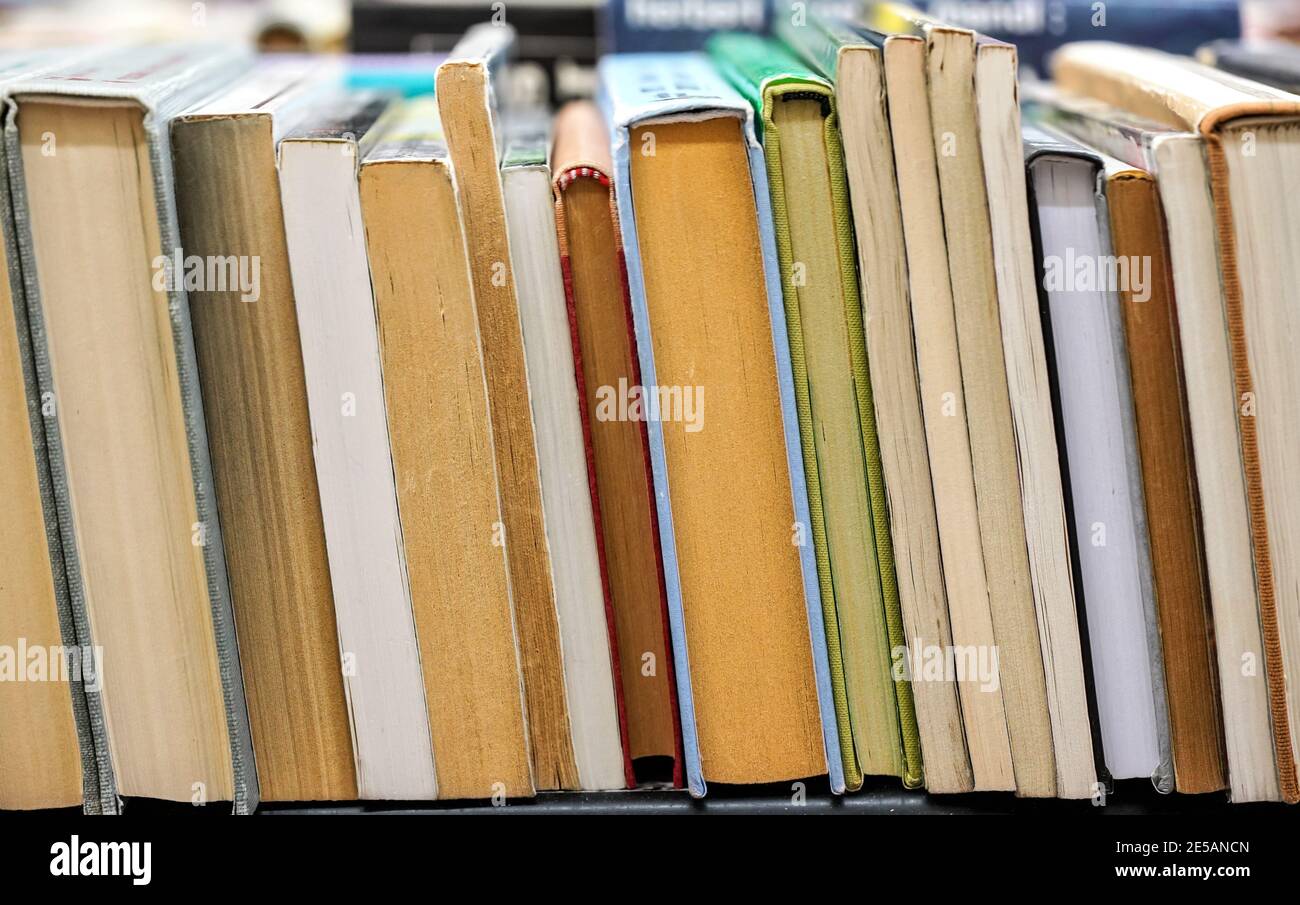 Row of many old used books displayed at local antiquarian bookshop ...