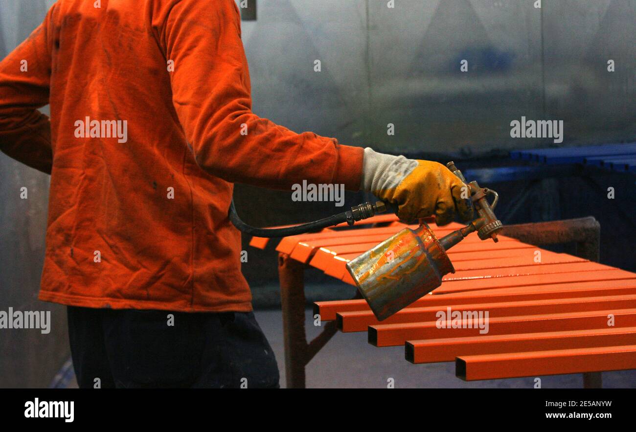 Metal painting worker in factory Stock Photo - Alamy