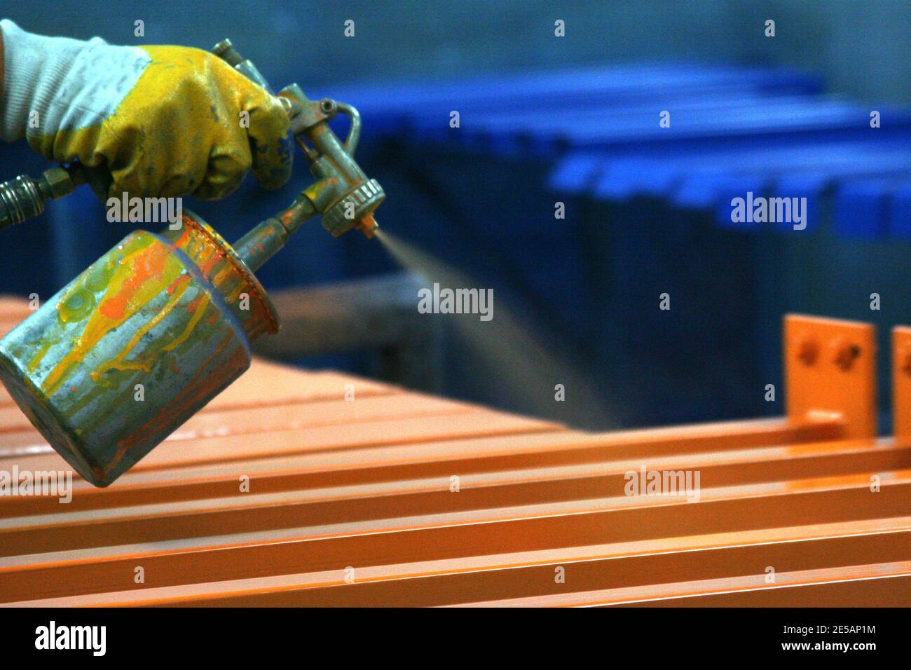 Metal painting worker in factory Stock Photo - Alamy