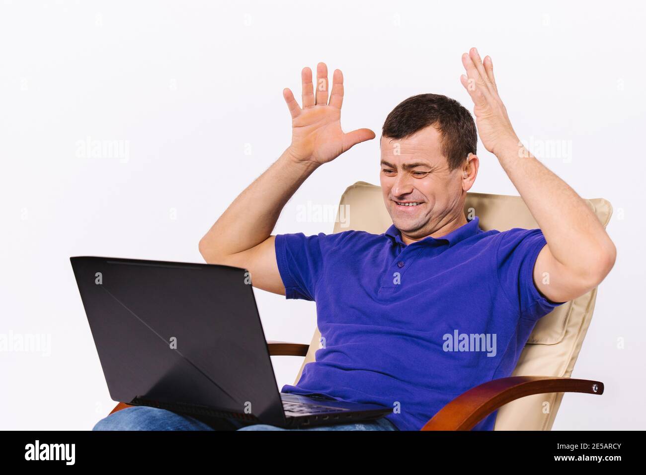 A deaf man with a laptop raised both hands up in a gesture indicating ...