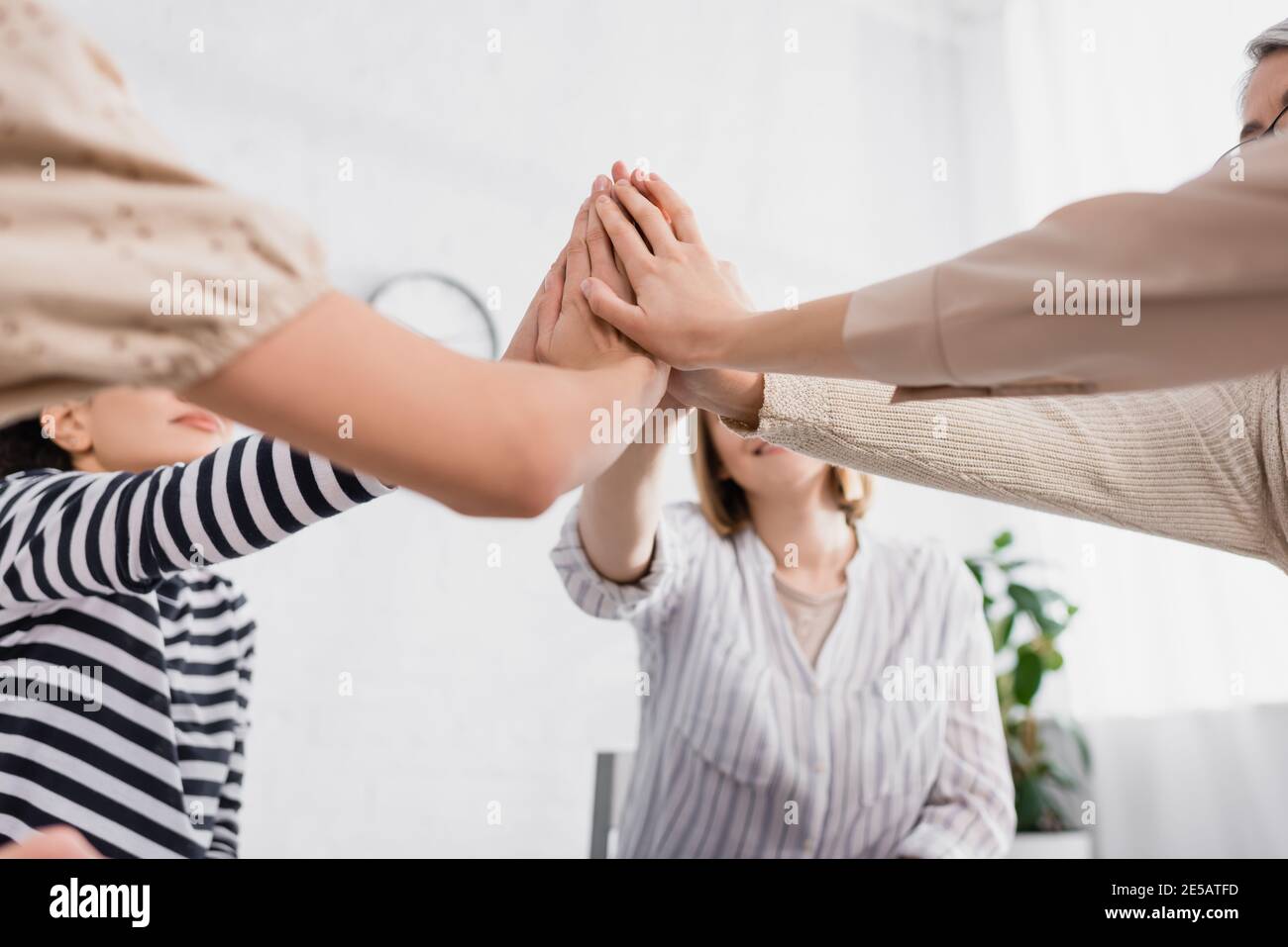 group of women holding hands together during seminar Stock Photo - Alamy