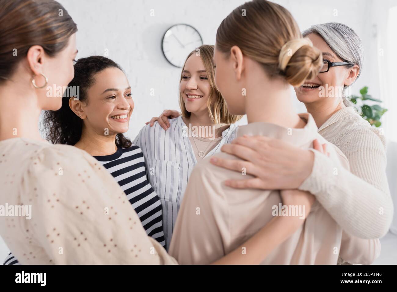 happy multicultural female team hugging during seminar Stock Photo - Alamy