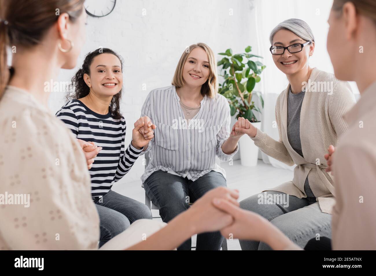 Hold hands sit group hi-res stock photography and images - Alamy