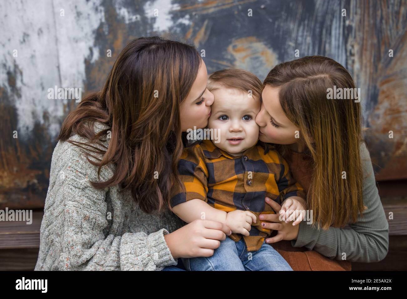 Two sisters and a little baby brother sitting on steps outside for a ...
