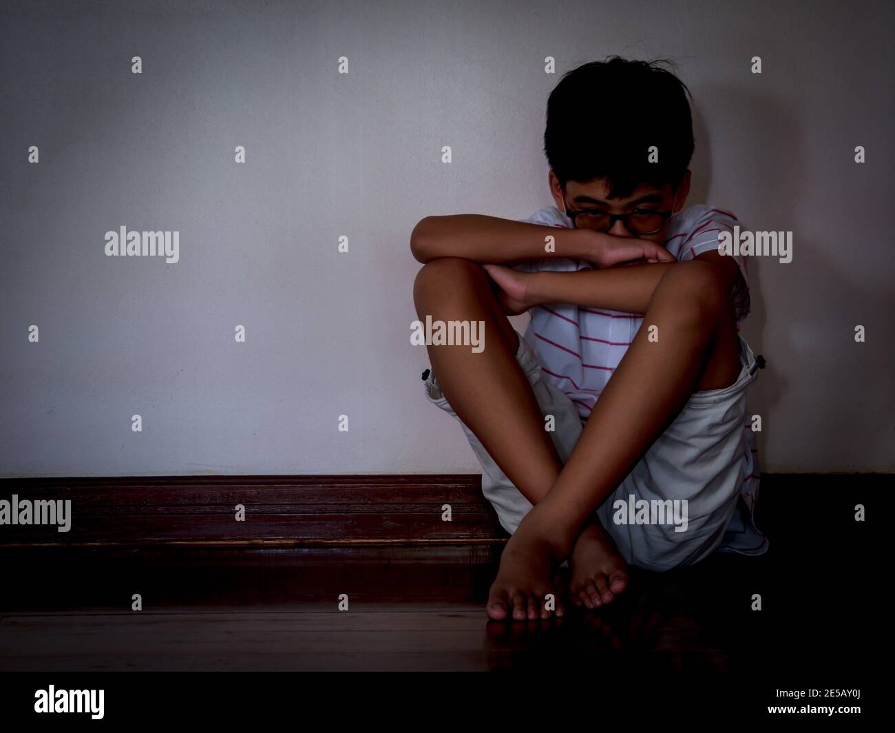 Neglected Lonely Child Leaning At Room corner with sadness and unhappy ...