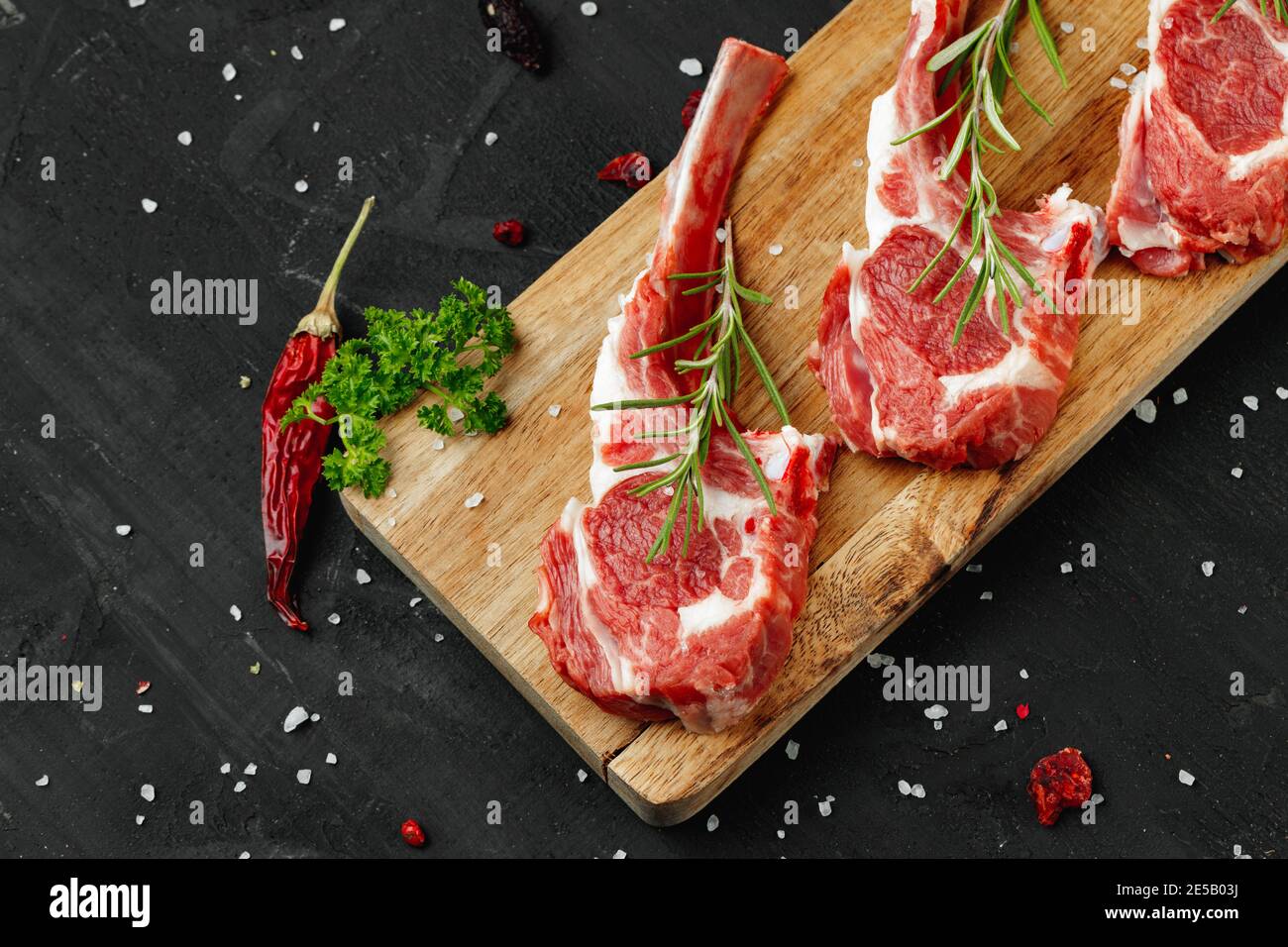 Racks of lamb ready for cooking on dark background Stock Photo - Alamy
