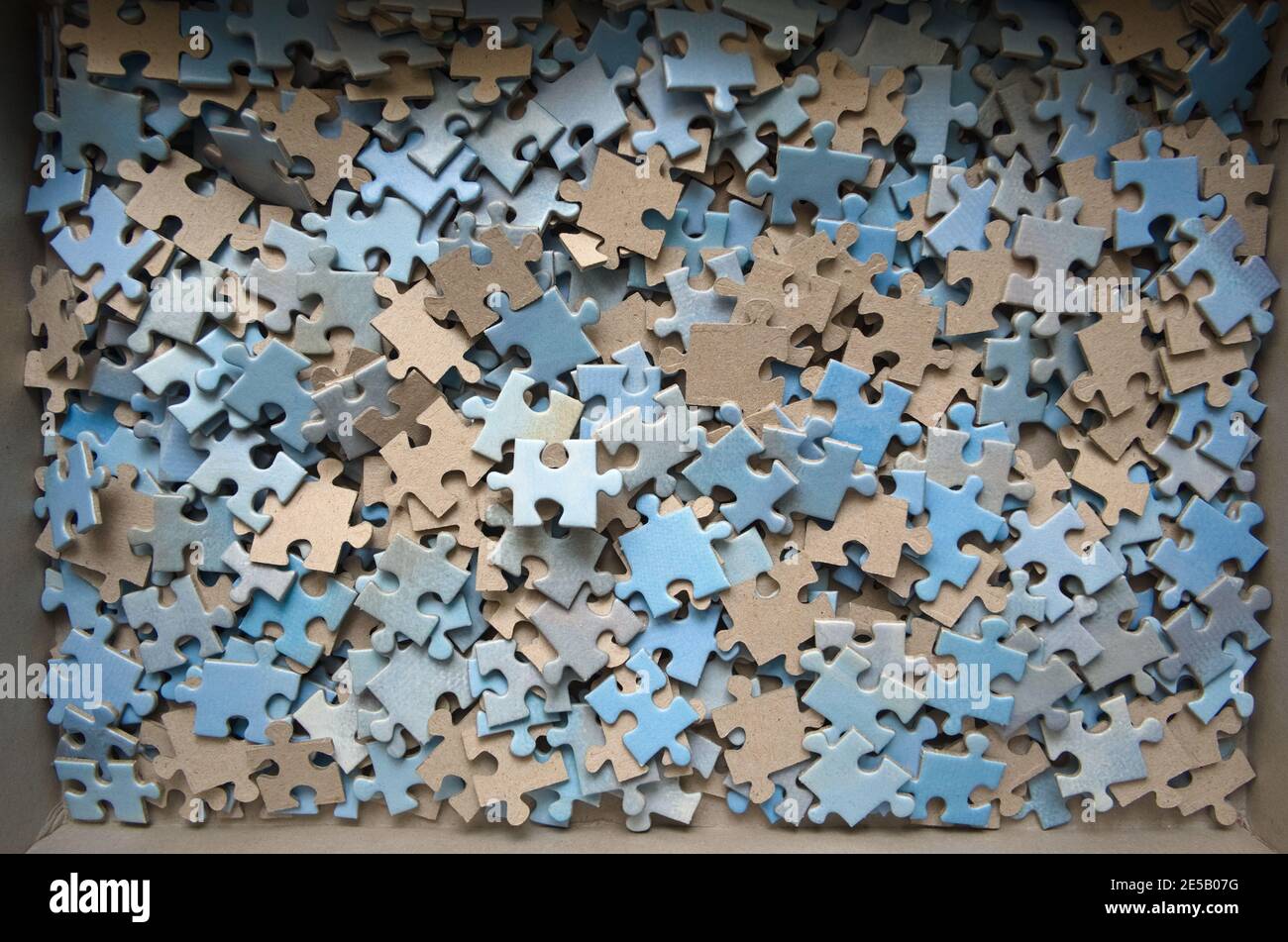 Puzzle pieces in the box mostly blue and white colors Stock Photo - Alamy