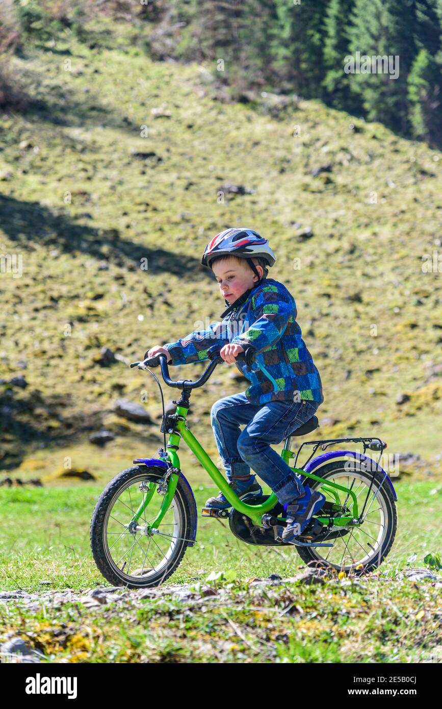 Little boy cycling in beautiful springtime nature Stock Photo - Alamy