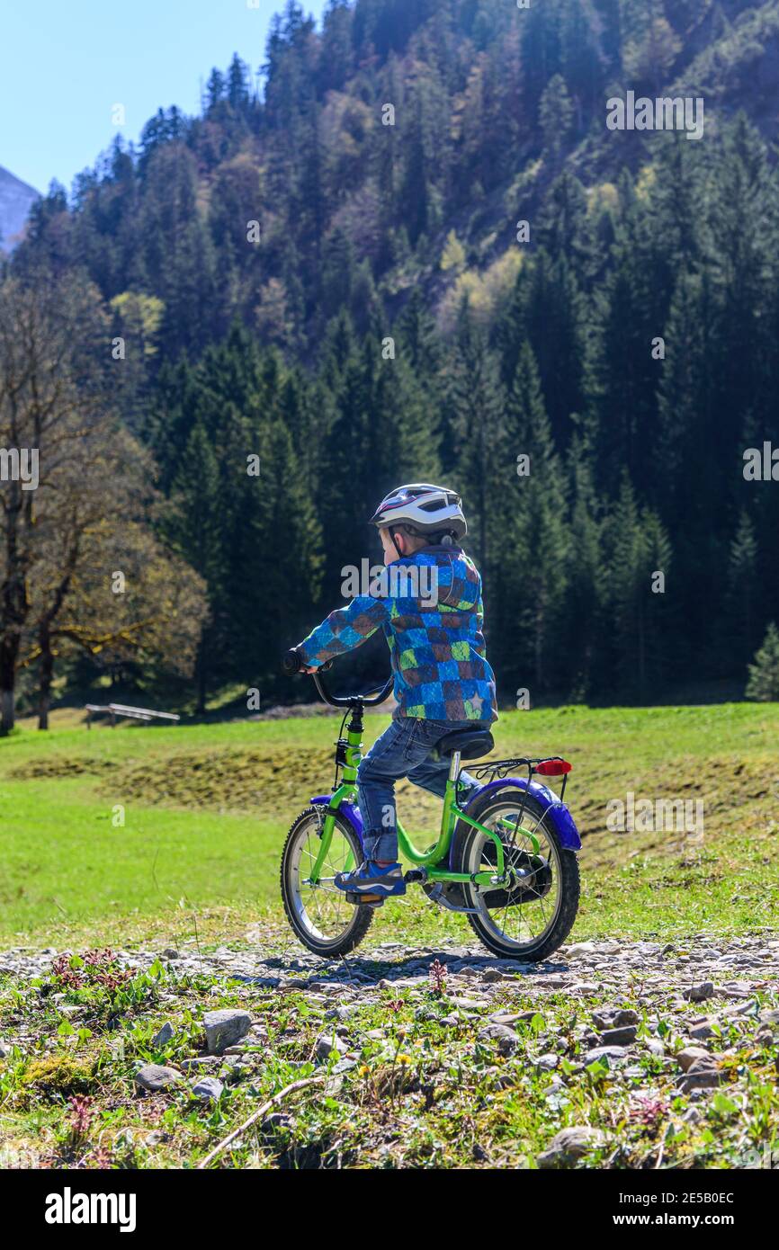 Little boy cycling in beautiful springtime nature Stock Photo - Alamy