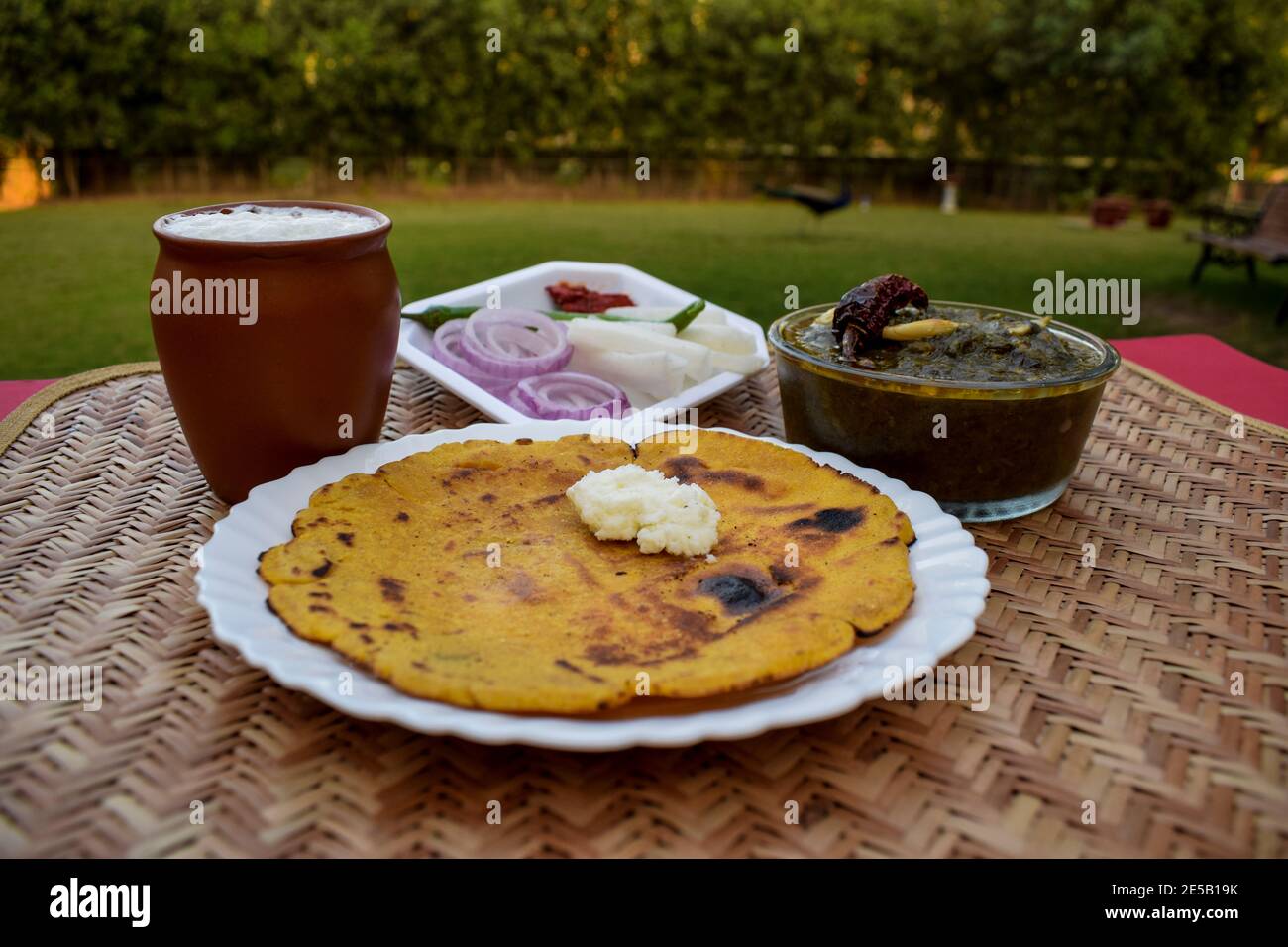 Side view of makki di roti and Sarson da saag, mustard leaves curry and ...